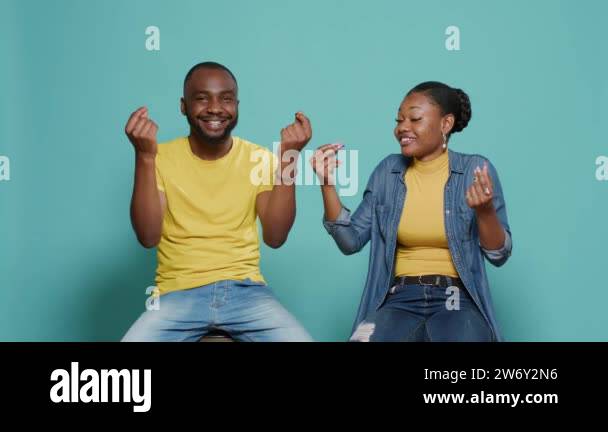 People using body language to do money gesture with hands in studio ...