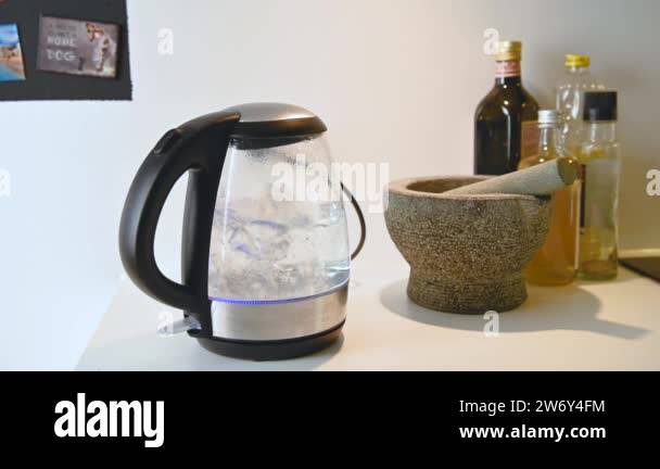 Boiling water in a kettle, in a kitchen. Real time clip, starting just ...