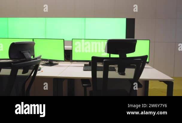 Empty office, desk, and chairs at a main CCTV security data center with ...