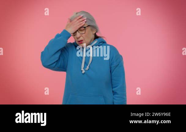 Upset senior granny woman making face palm gesture, feeling bored ...