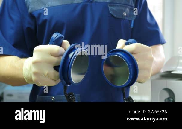 Defibrillation concept. Defibrolator in hands from eyes of patient. POV ...