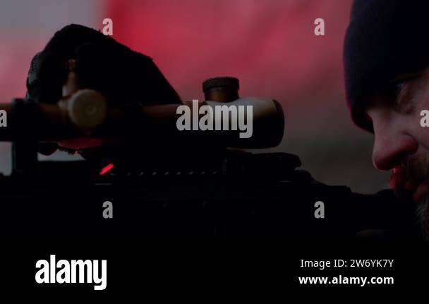 Hitman holding modern rifle. Professional sniper aiming target on ...