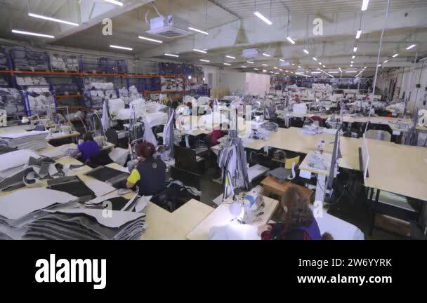 There are many seamstresses in the workshop during time laps. Women in ...