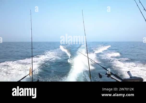 Fast fishing boat creating splashing waves at sea. Boat sail fast over ...