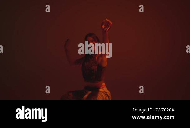 Stylish girl dancing hip-hop, hot dance in spotlight. Youth rap culture ...