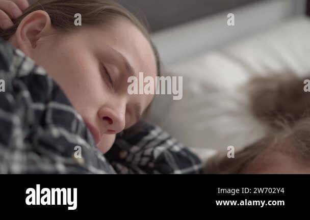 Authentic cute young mom fell asleep read fairy tale from book to baby ...