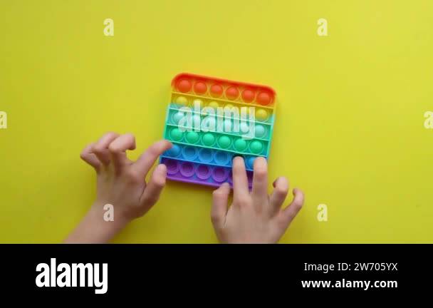 Popit antistress toy for children entertainment on a yellow background ...