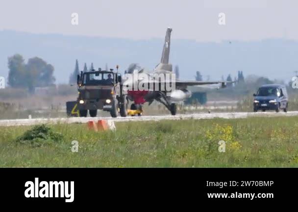 Tractor tows a modern fighter jet plane at a NATO airbase Stock Video ...