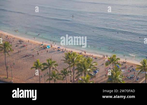 Tourists enjoy the warm sun on a tropical beach. Amazing sunset at ...