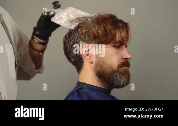 Hair salon, hair coloring man. Process of a guy having his hair dyed at ...