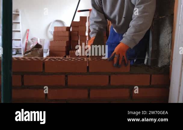 Construction worker building a brick wall. Man bricklaying. Mason ...