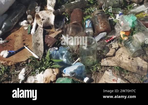 garbage dump outdoors. close-up. rubbish pile of broken glass jars ...