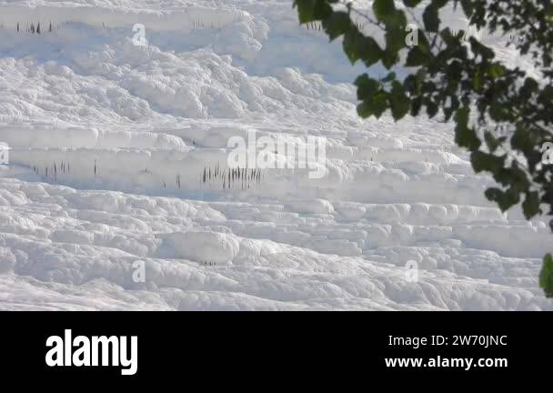 White travertine rock formed with the calcium carbonate mineral in the ...