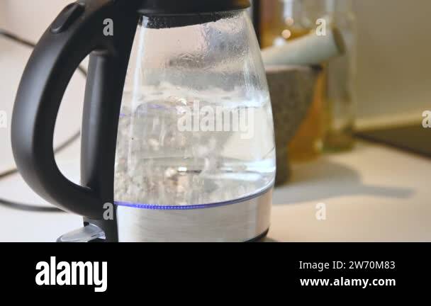 Boiling water in a kettle, in a kitchen. Real time clip, starting just ...