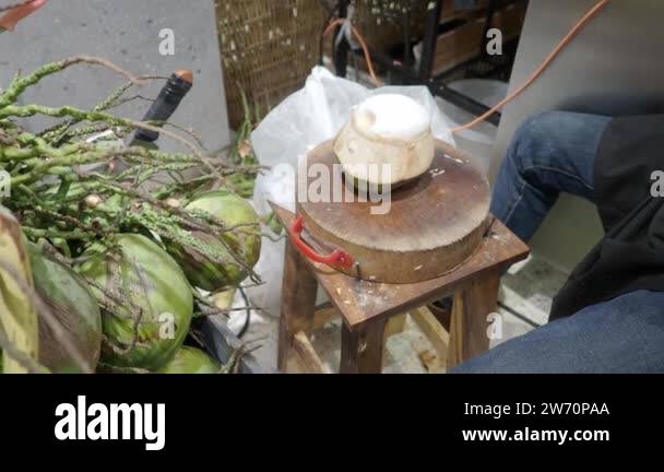 Peeling Thai coconut skin in the traditional way. Which keeping coconut ...