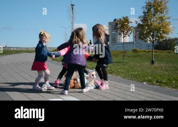 four little girls sisters have fun in the park Stock Video Footage - Alamy