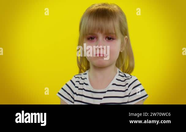 Disappointed upset kid child girl with tears on eyes cries from despair ...