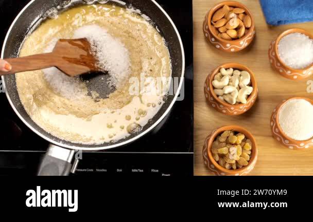 Female's hand mixing white refined sugar with Sooji/Suji/semolina Halwa ...