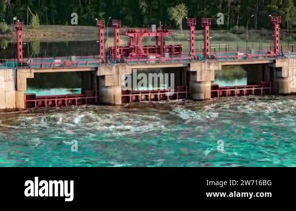 Timelapse with a river, dam, bridge, and cars. Car and pedestrian ...