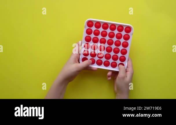 Popit antistress toy for children entertainment on a yellow background ...