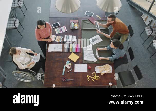 Designers sitting around table in Stock Videos & Footage - HD and 4K ...
