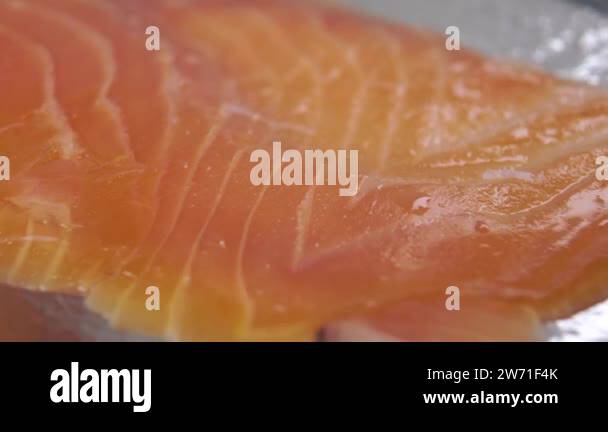 A piece of cooked salted fresh salmon fish is stacked in a stack. Macro ...