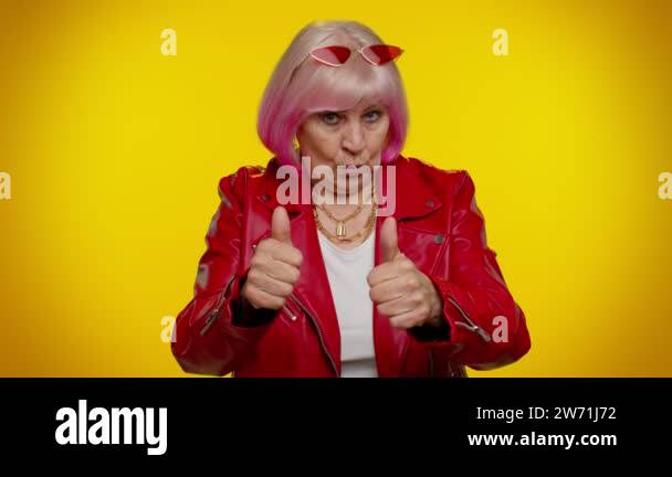 Mature old granny grandmother showing thumbs up and nodding in approval ...