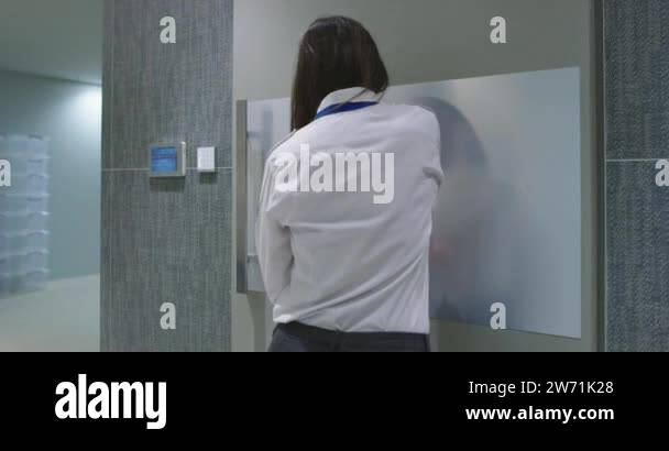 Security opening a wheel of large vault metal door with various access control devices, security ...