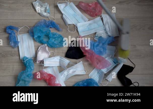 Covid-19 single-use waste. Used medical masks and gloves on the floor ...