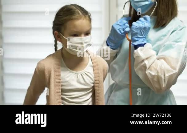 Cute kid patient visiting female doctor pediatrician nurse holding ...