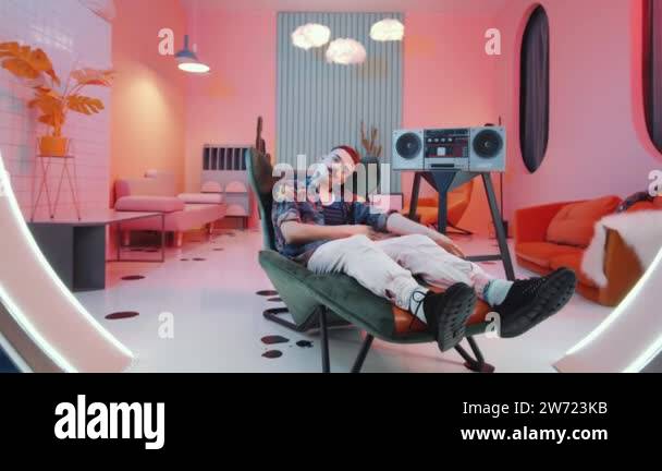 Zoom in shot of stylish man with mustache and bowl haircut chilling on ...