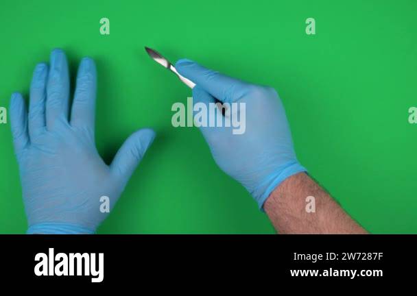 hands in medical gloves make incisions with a scalpel. acute hururgic ...