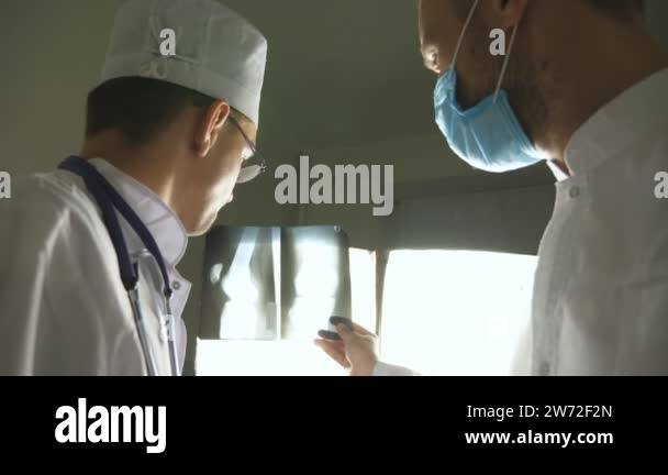 Two caucasian doctors view mri picture and discussing about it. Male ...