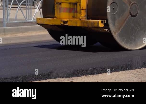 A layer of freshly laid asphalt in the rays of the setting sun. Road ...