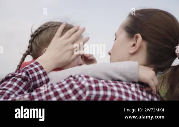 Mommy soothes baby. child is crying in park in arms of mom. family ...
