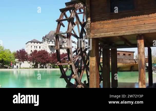 Old water mill. Mill wheel movement. HD video. Splashes and streams of ...