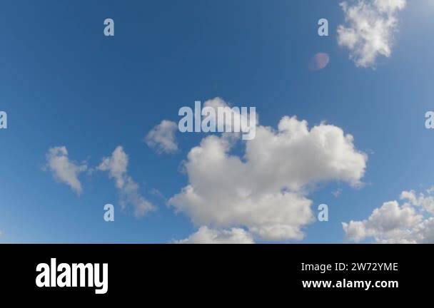 Blue sky white clouds. Puffy fluffy white clouds. Cumulus cloud cloudscape timelapse. Summer ...