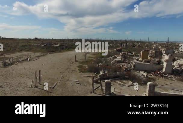 Aerial drone scene of demolished, destroyed city. Camera moves to the ...