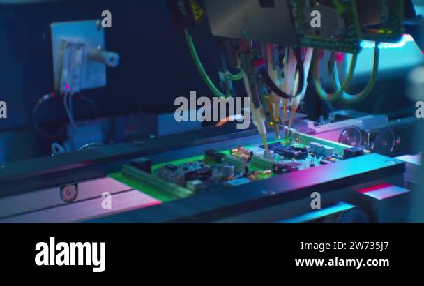 Assembly of a complex electronic board by an industrial robot.Cose-up ...