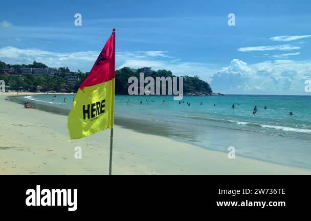 thailand, phuket swim here flag. safety and risk on the beach of sea ...