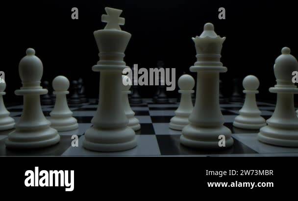 Game of chess. Filmed in a dark key. White moves with a pawn. Super ...
