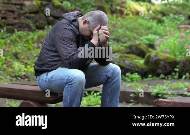 Man praying on bench Stock Videos & Footage - HD and 4K Video Clips - Alamy