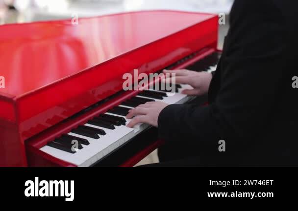 Pianist plays beautiful red grand piano. Romantic atmosphere, perfect ...