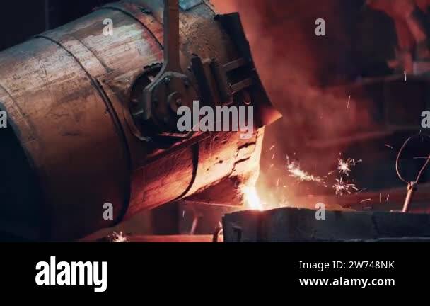 Process of casting molten metal or iron into mold from ladle. Steel ...