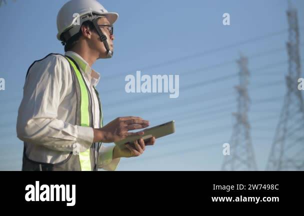 Engineer concept of 4k Resolution. An employee is using a tablet to ...