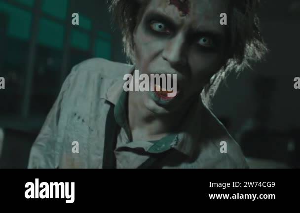 Close up shot of zombie man with SFX makeup with fake wounds and white ...