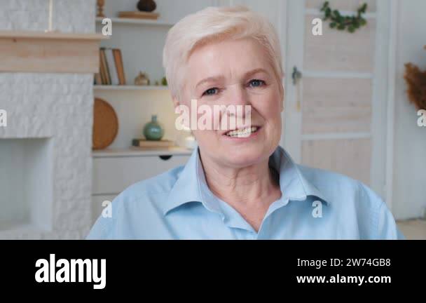 Happy healthy middle aged beautiful grandma looking at camera ...