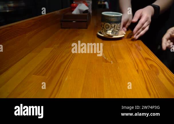 tea drinking in cosy restaurant. waiter serves coffee or tea. faceless ...