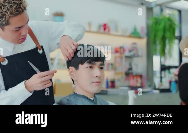 Slow motion camera movement. Professional barber cuts men using ...