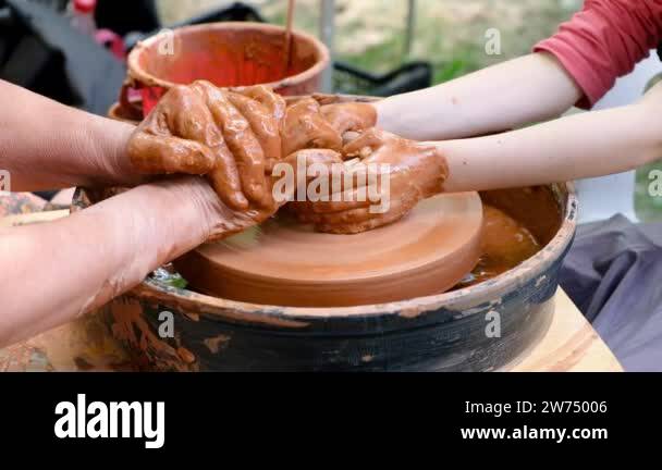 Woman and girl making ceramic pot in pottery workshop. Female hands on ...